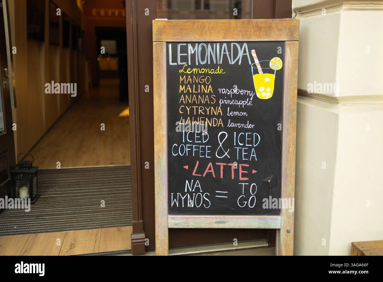 Chalkboard menu with lemonade and iced coffee offers outside a cafe ...