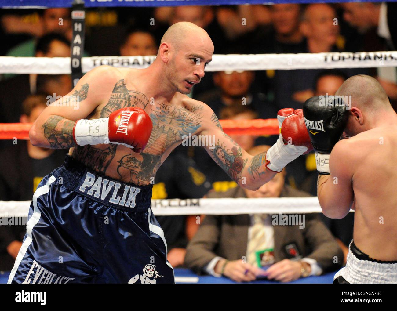 2012 JUN 08: Kelly Pavlik (blue trunks) throws a punch at Scott Sigmon ...