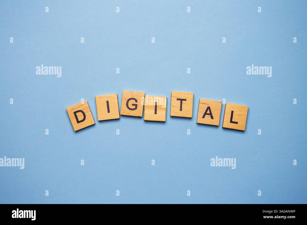 Wooden letter tiles spelling the word 'DIGITAL' arranged on a light ...