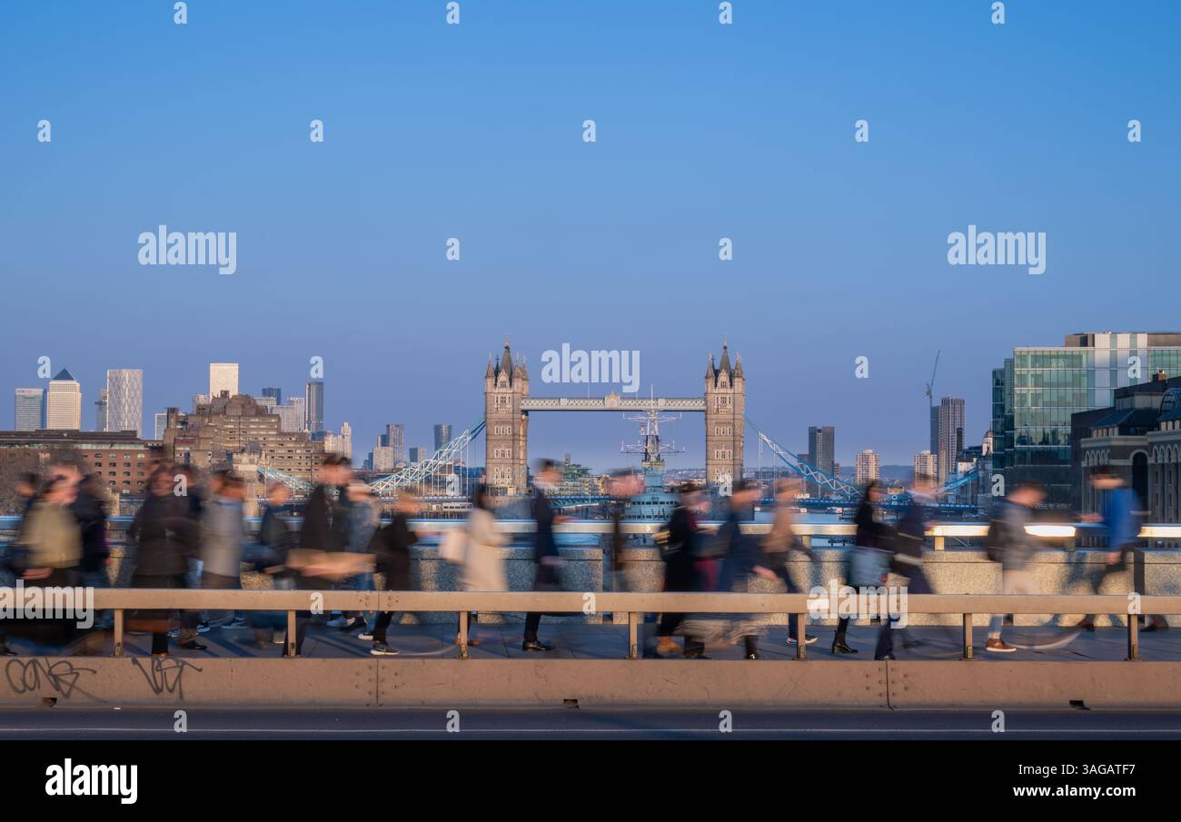 London, UK: People walking on London Bridge with movement blur. Tower ...