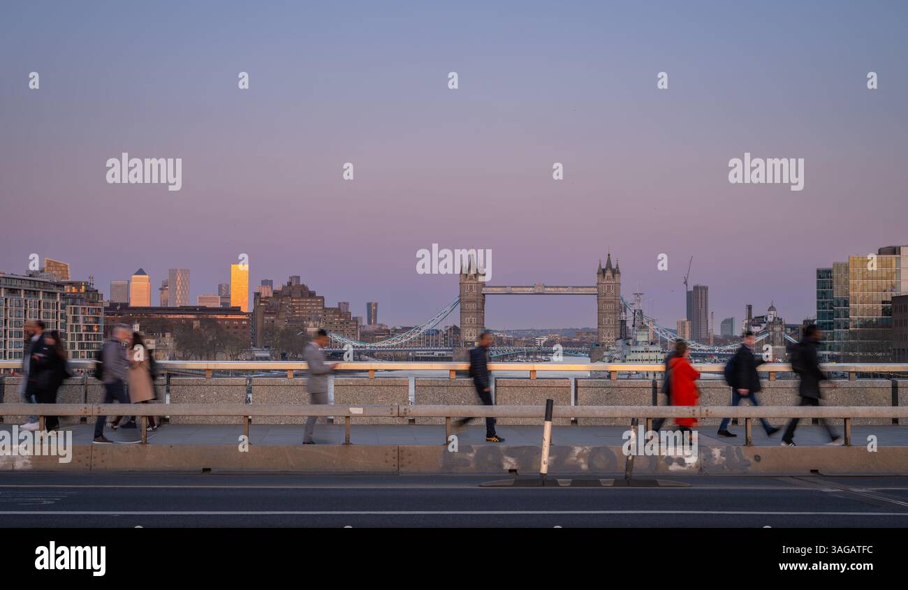 London, UK: People walking on London Bridge with movement blur. Tower ...