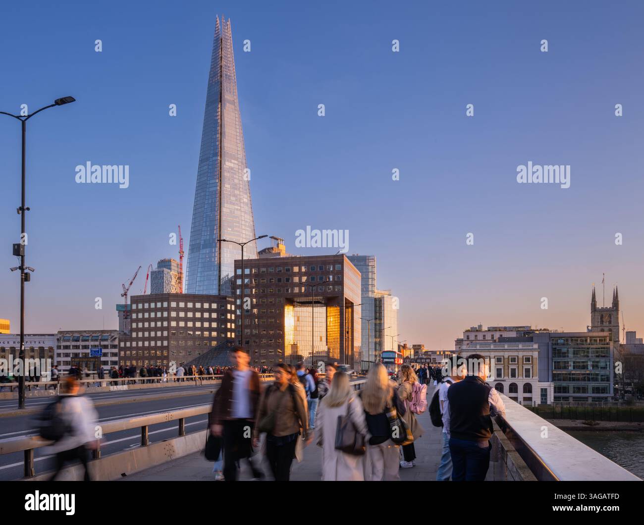 London, UK: People walking on London Bridge with movement blur. The ...