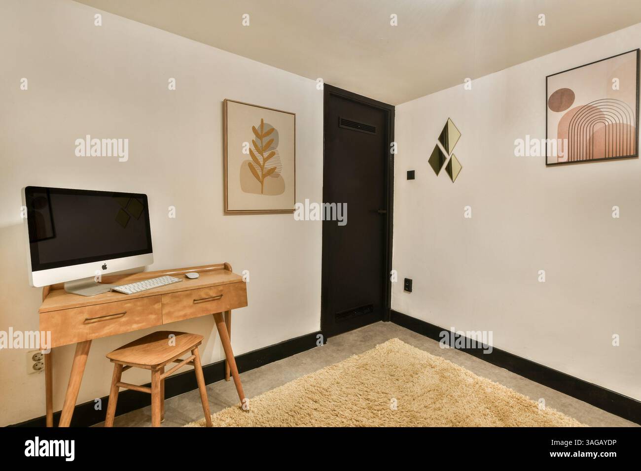 A stylish, minimalist interior featuring a desk, artwork, and neutral ...