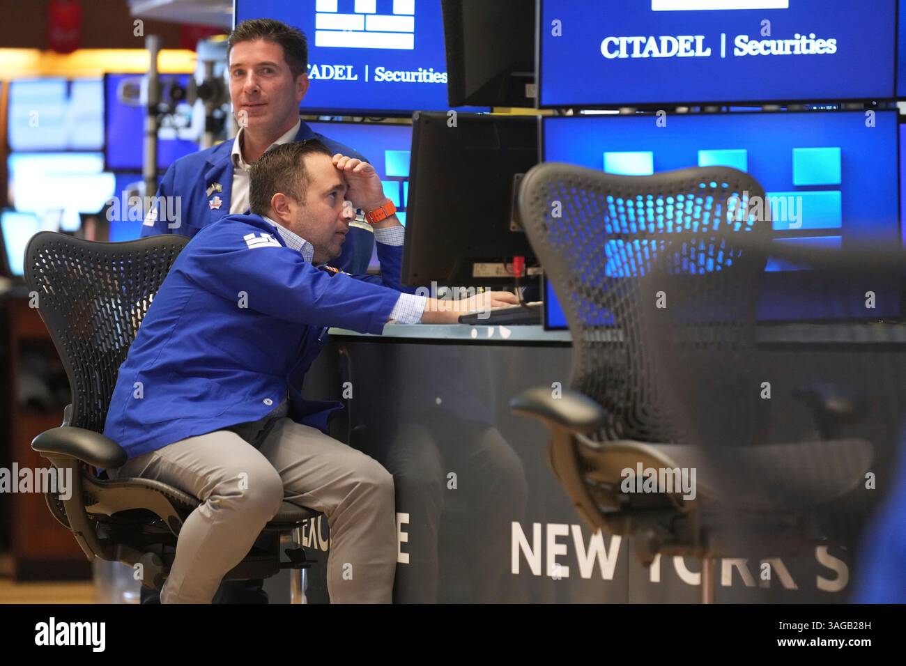 Traders work on the floor at the New York Stock Exchange in New York ...