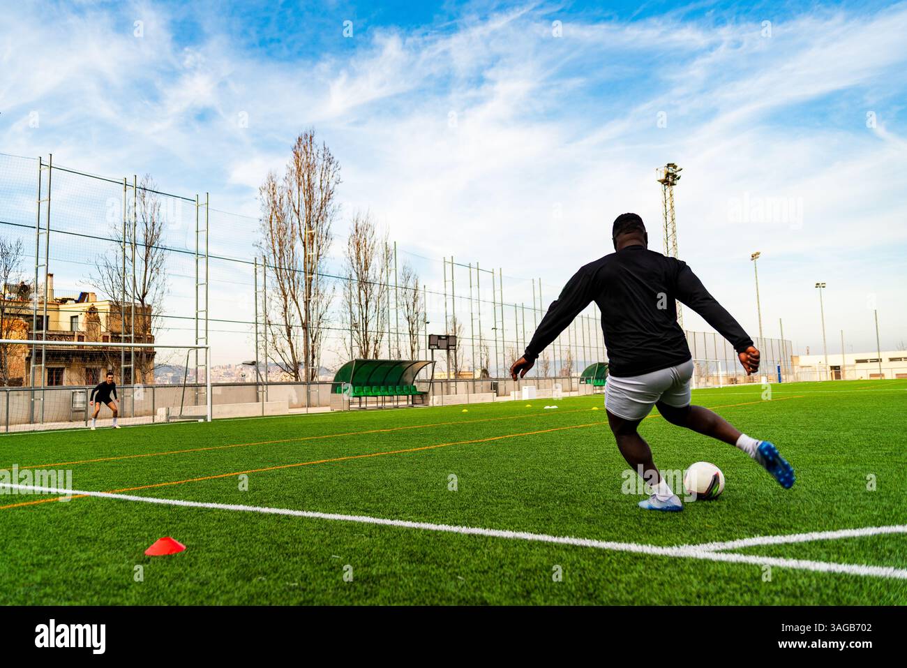 African black young adult training in a football pitch. Team of young ...