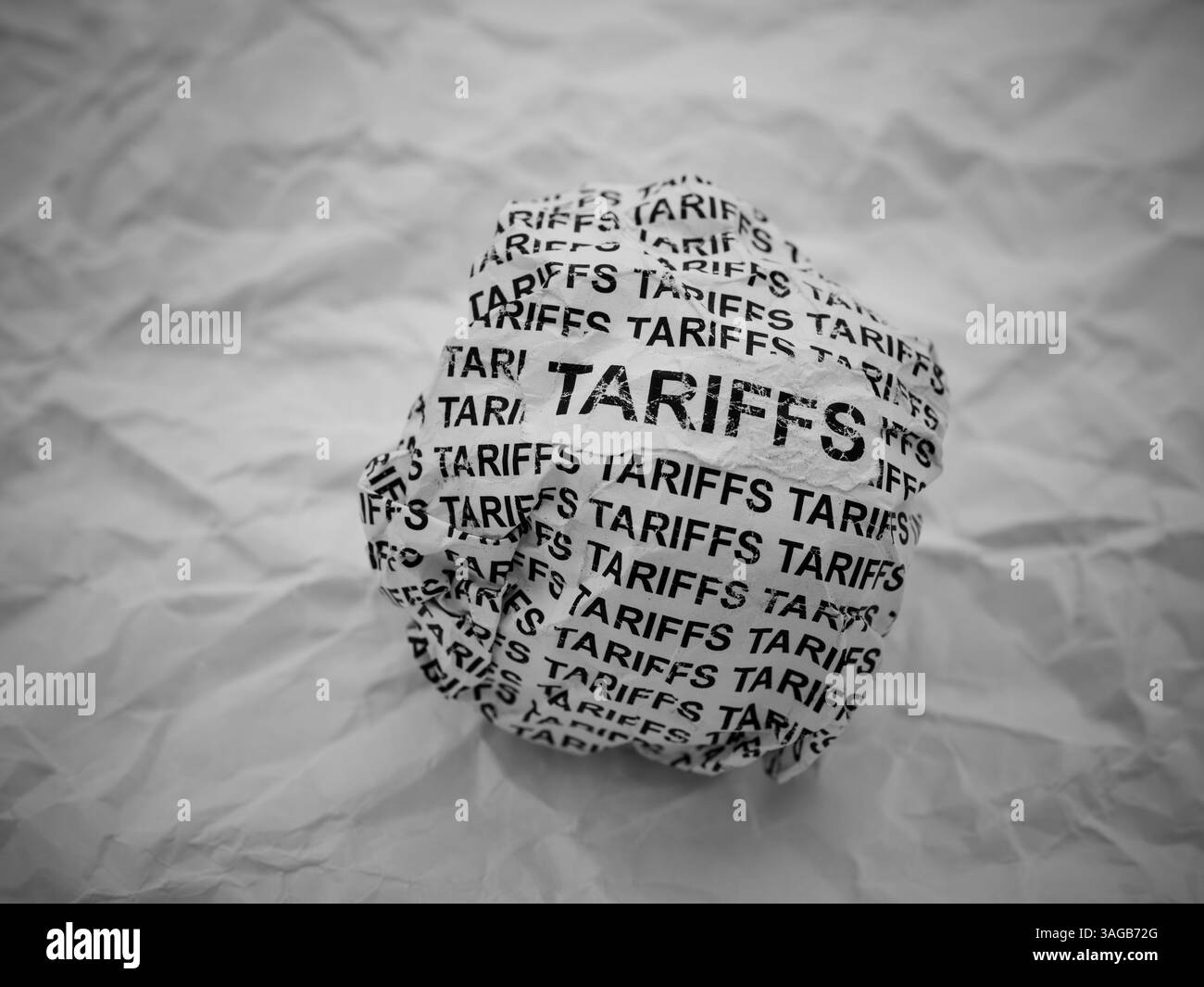 Crumpled paper ball with words Tariffs on a crumpled white paper ...