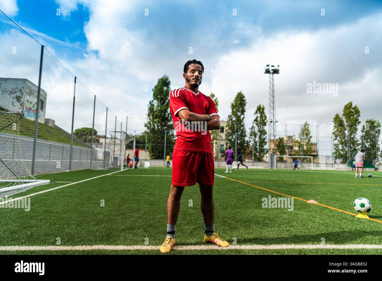 Portrait of young arab football player in outdoors football field ...