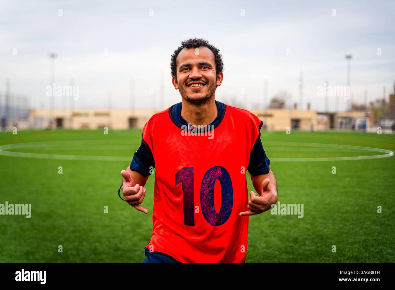 Portrait of young arab football player in outdoors football field ...