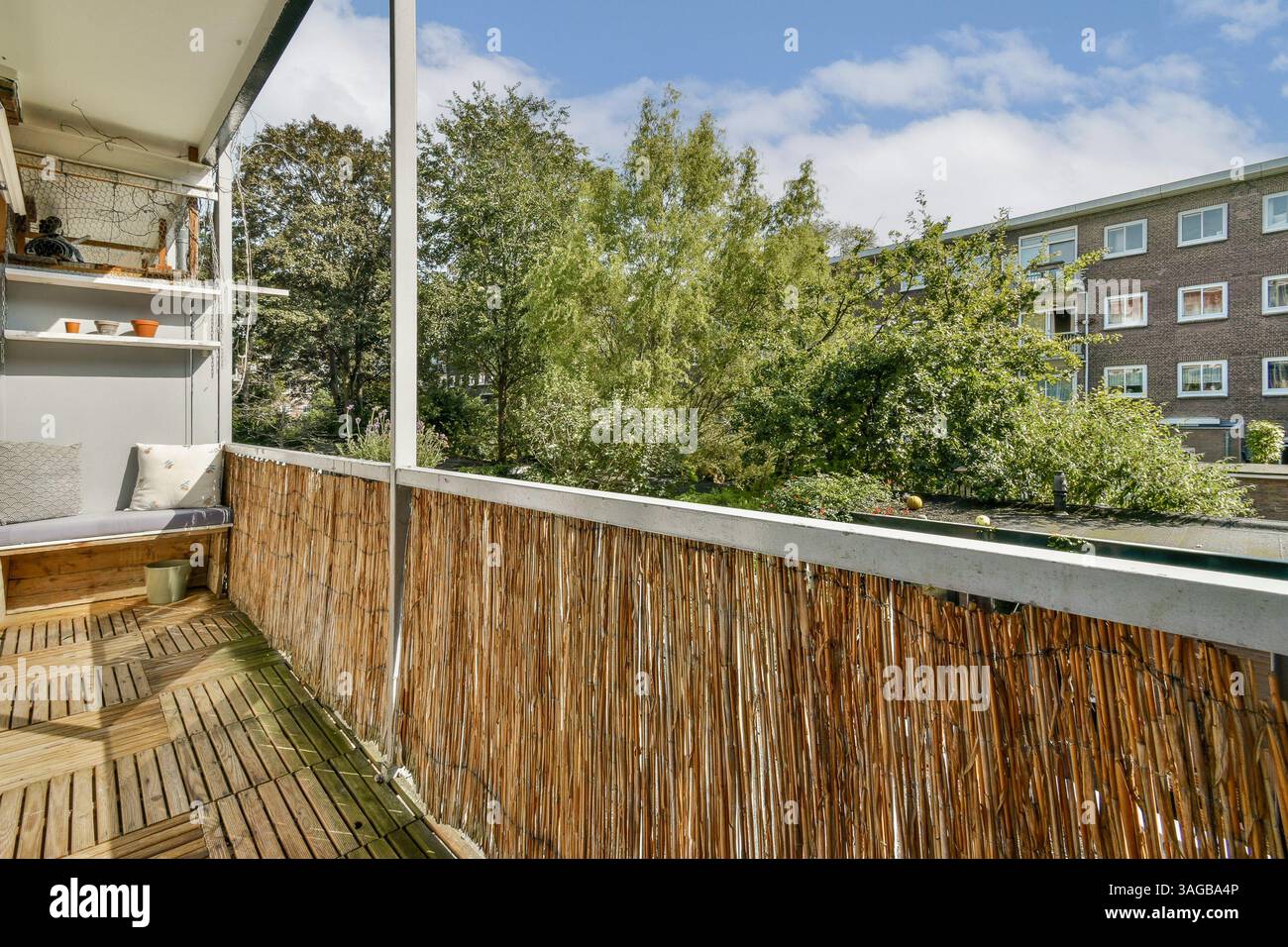 A serene balcony featuring wooden decking, natural bamboo railing, and ...