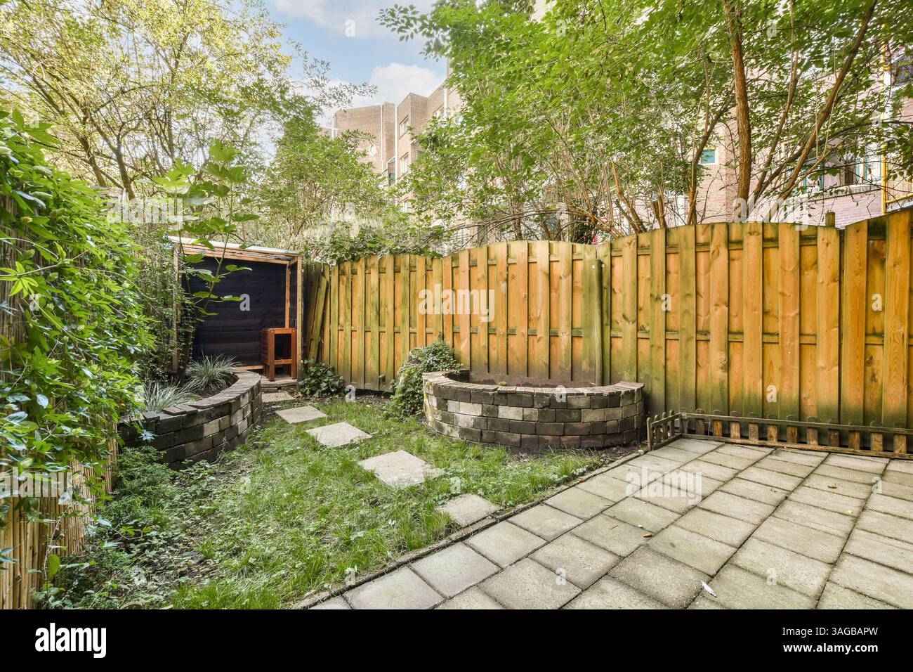 A serene urban garden featuring stone pathways, lush greenery, and ...