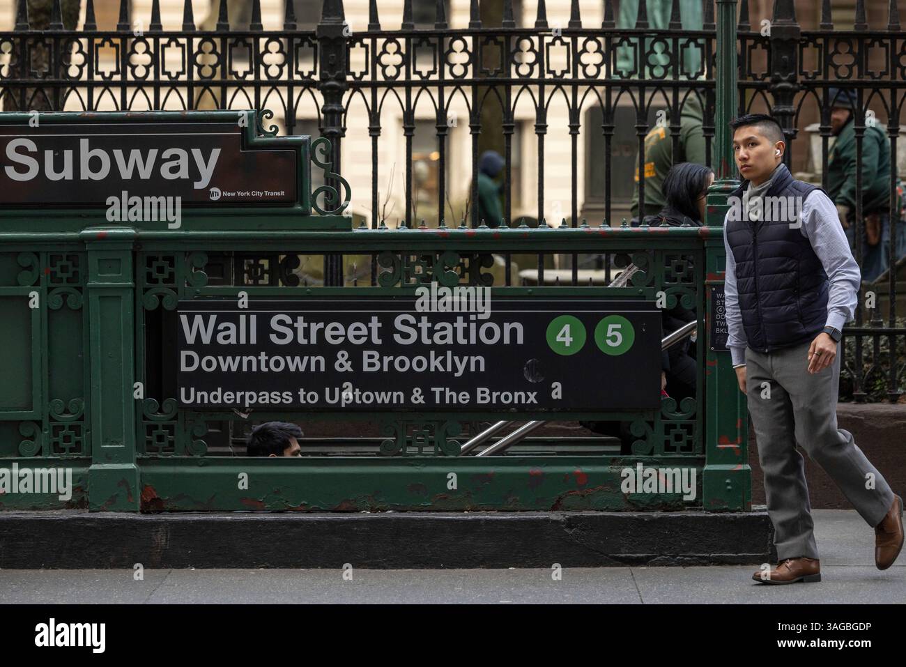 A commuter exits the Wall Street subway station, Tuesday, April 8, 2025 ...