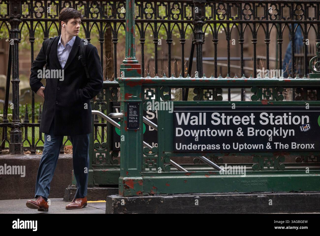 A commuter exits the Wall Street subway station, Tuesday, April 8, 2025 ...