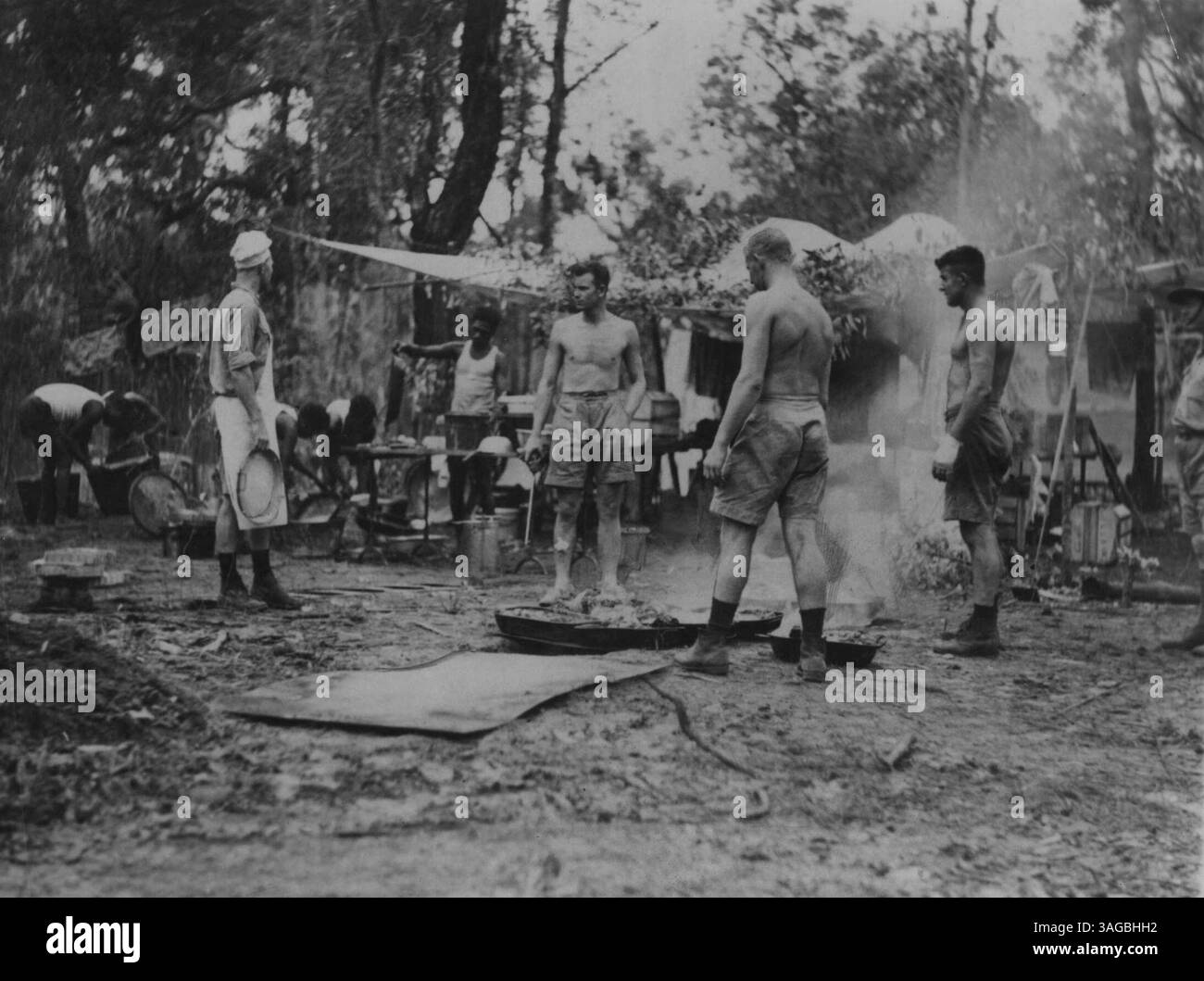 Darwins mobile force on manoeuvres. In the tropic bush back of Darwin, cooks prepare a meal in ...