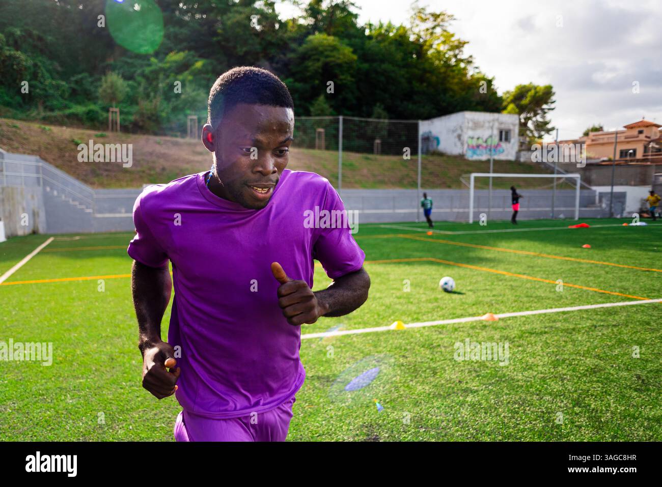 Portrait of young smiling black african man running and playing in a ...