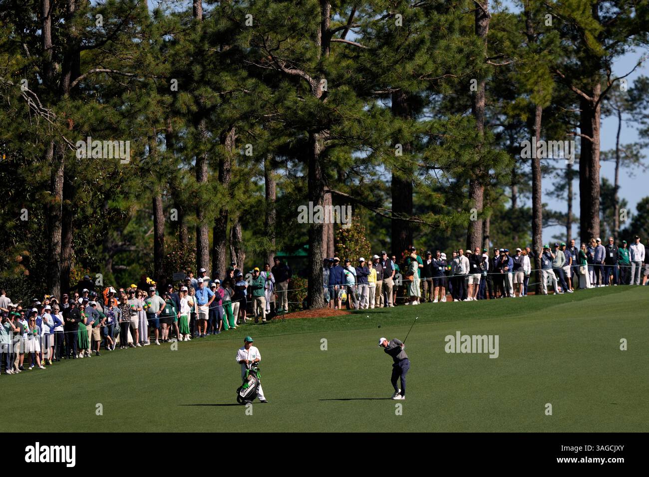 Tom Hoge hits from the 10th fairway during a practice round at the Masters golf tournament ...