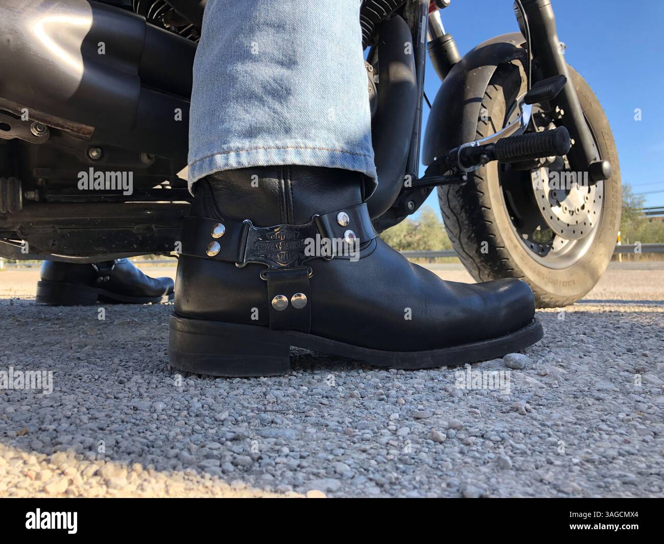 Bikers boot and motorcycle Stock Photo - Alamy