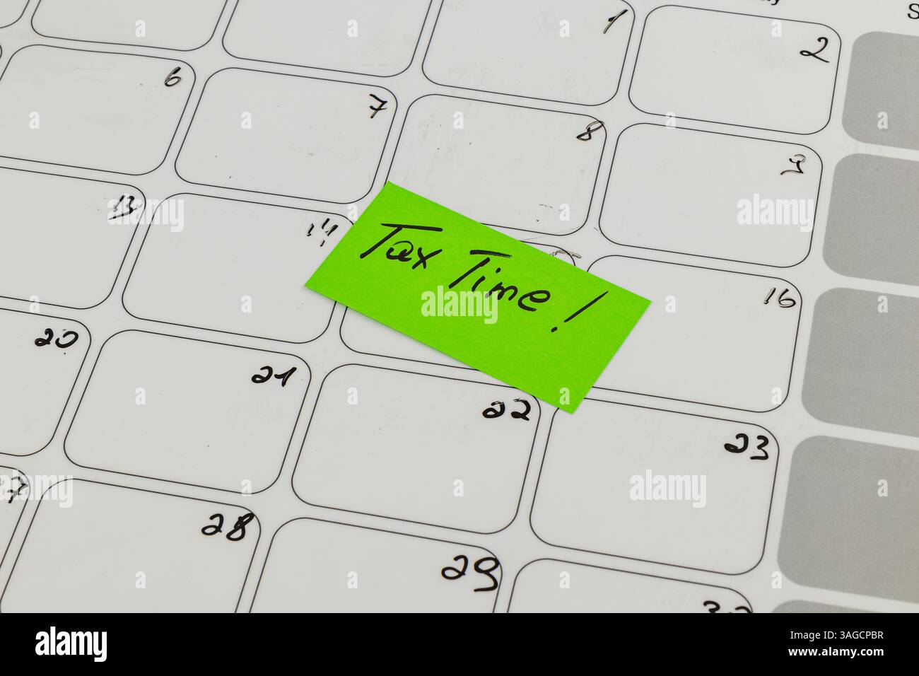A bright green sticky note on the whiteboard calendar highlights Tax ...