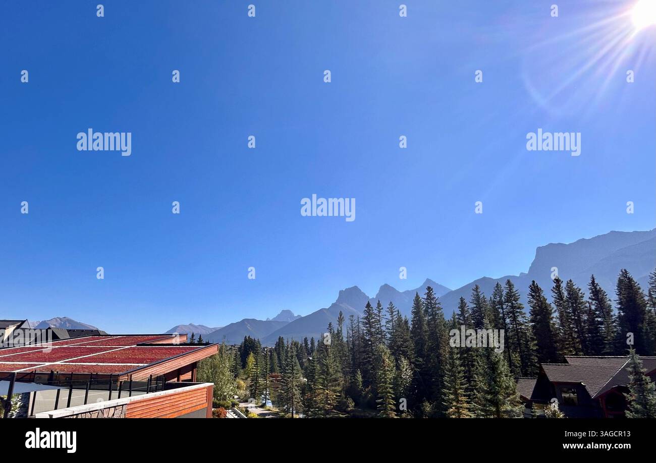 Sunny Mountain View with Rooftop and Trees Stock Photo - Alamy