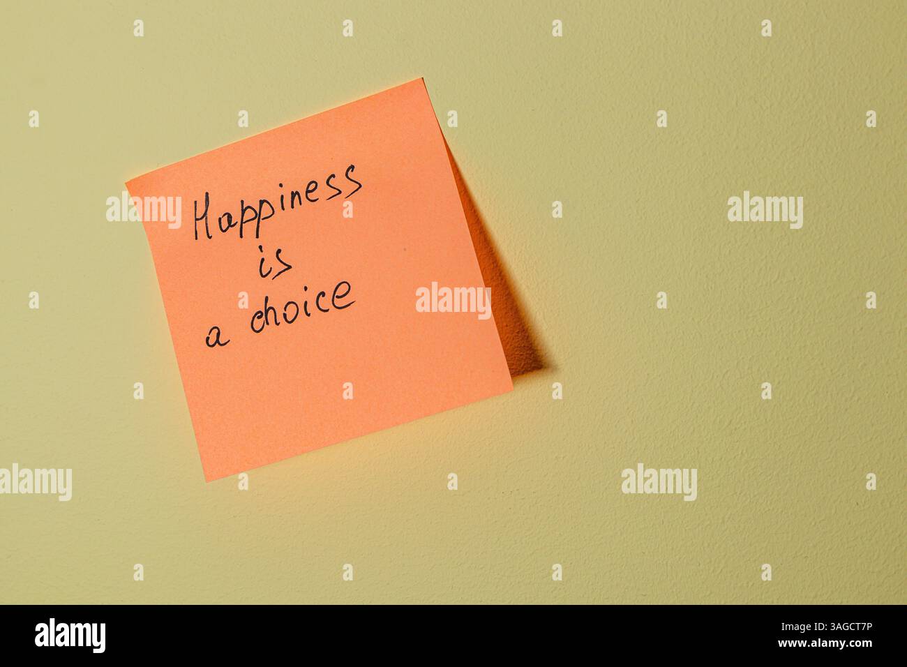 A bright orange sticky note with handwritten text displays the ...