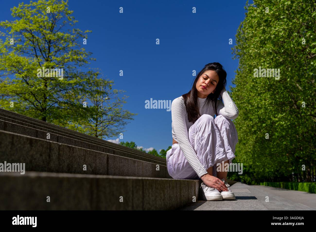 Beautiful Gen Z woman enjoying the sunlight on a wonderful day in ...