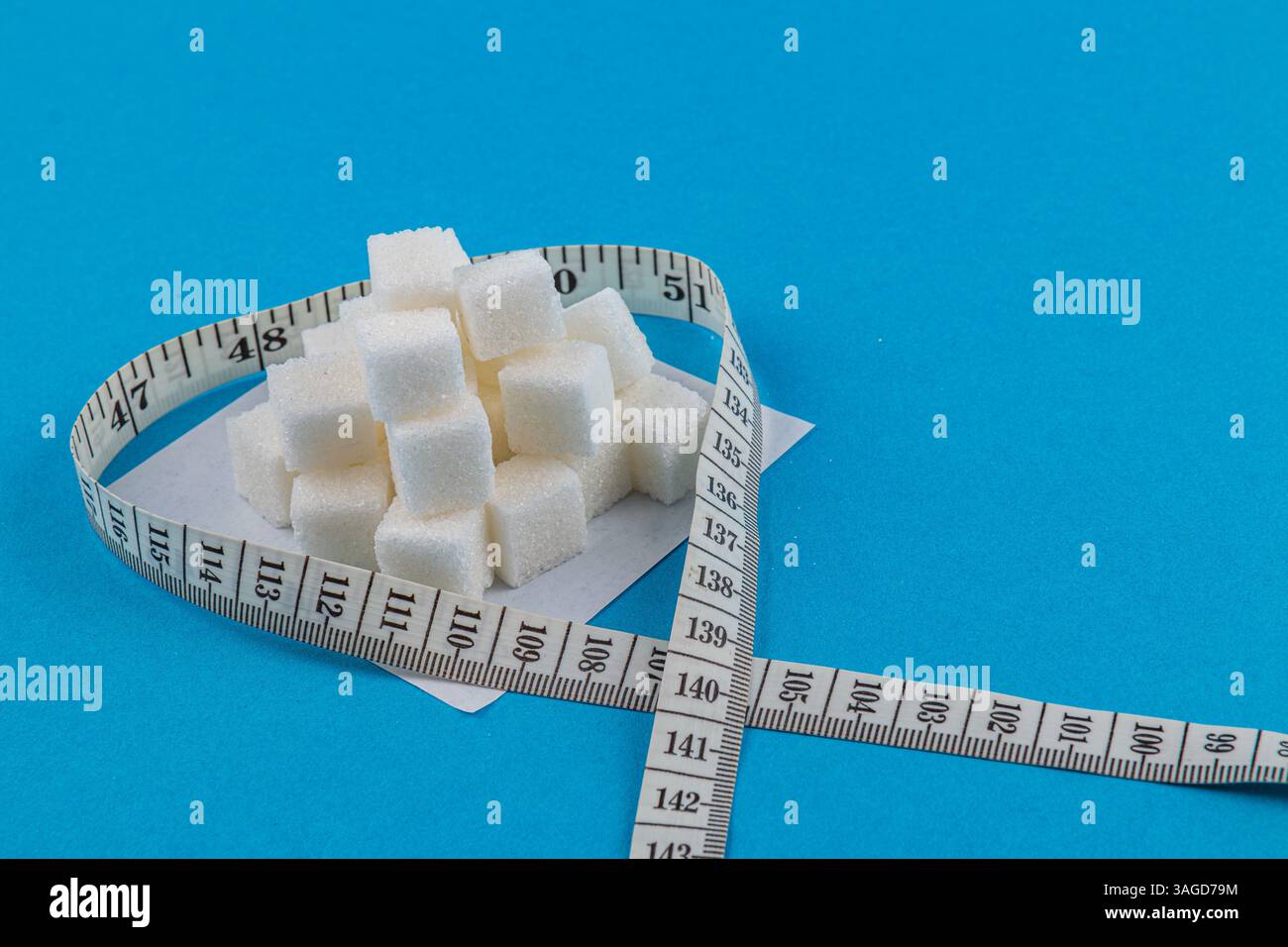 A heart shape is formed using measuring tape around a pile of white ...