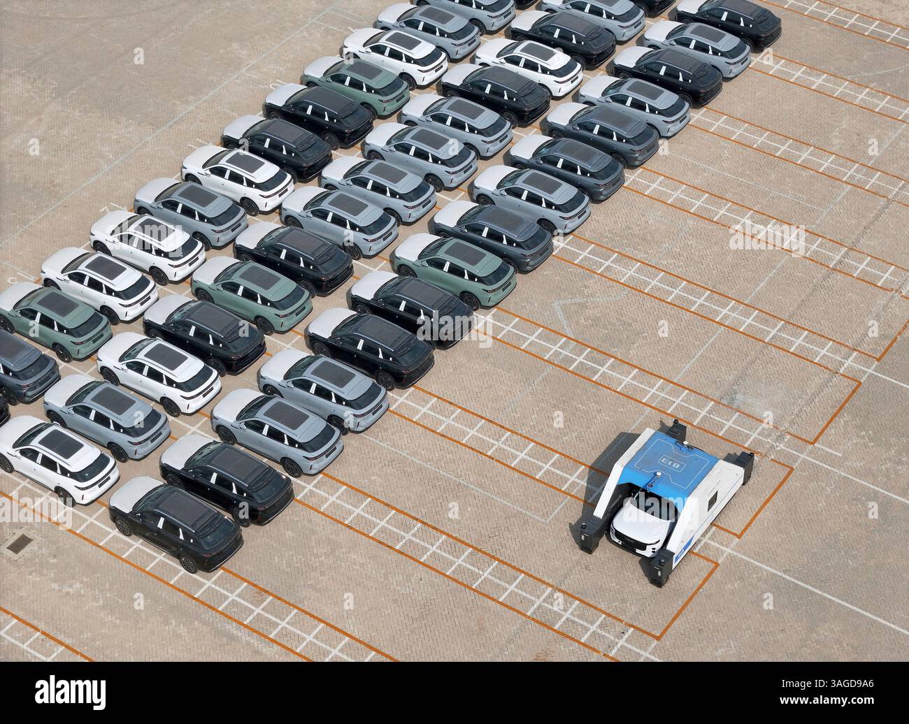 A car transporter carries a car in a parking space at the vehicle ...