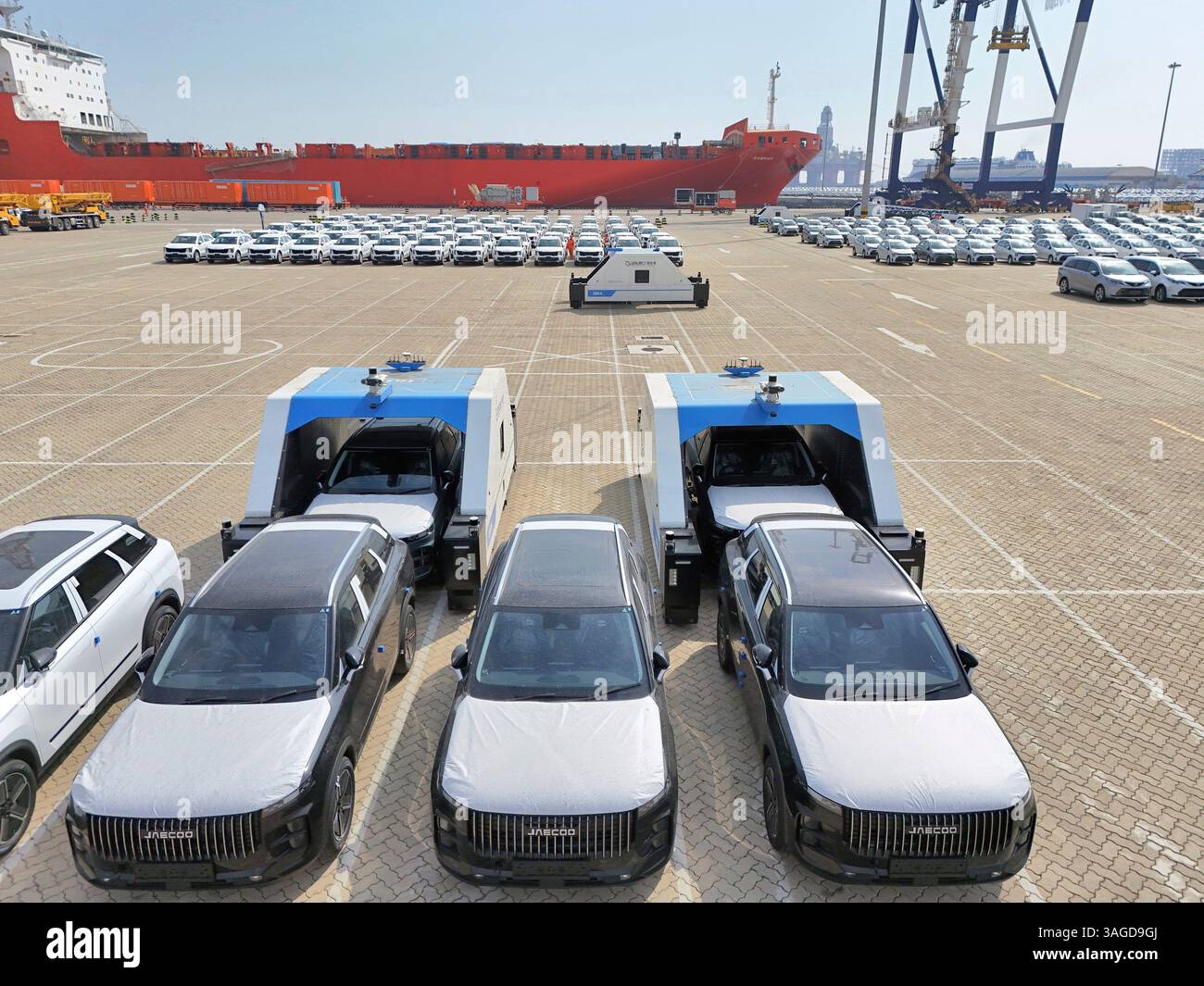 A car transporter carries a car in a parking space at the vehicle ...