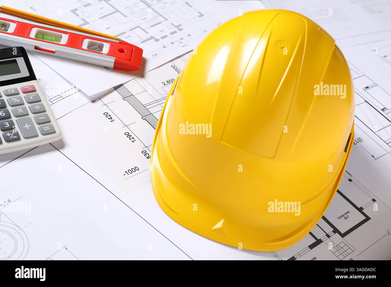 Hard hat, pencil, calculator and building level on different ...