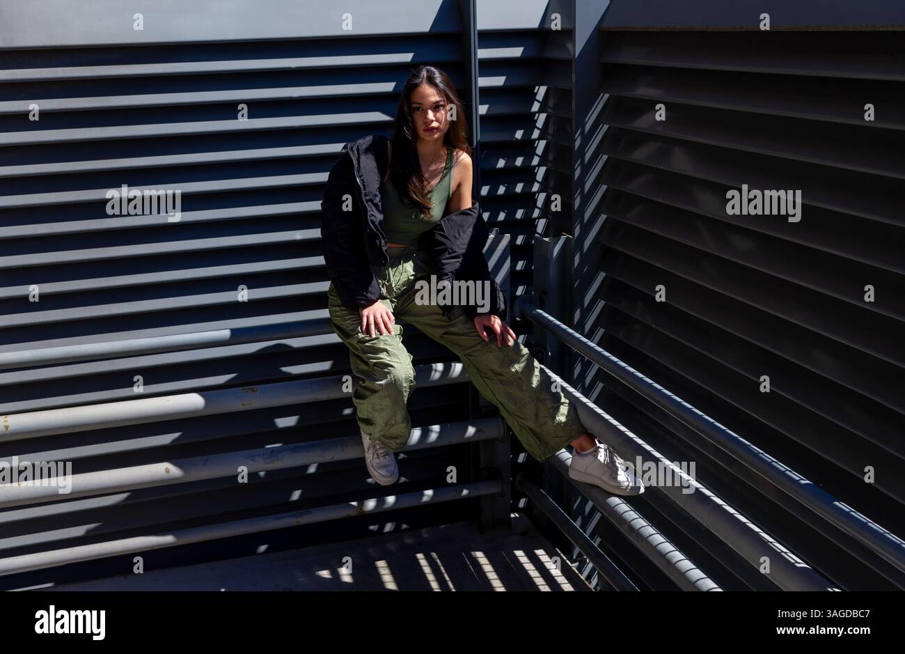 Beautiful Gen Z woman taking a break in a parking garage in the city of ...