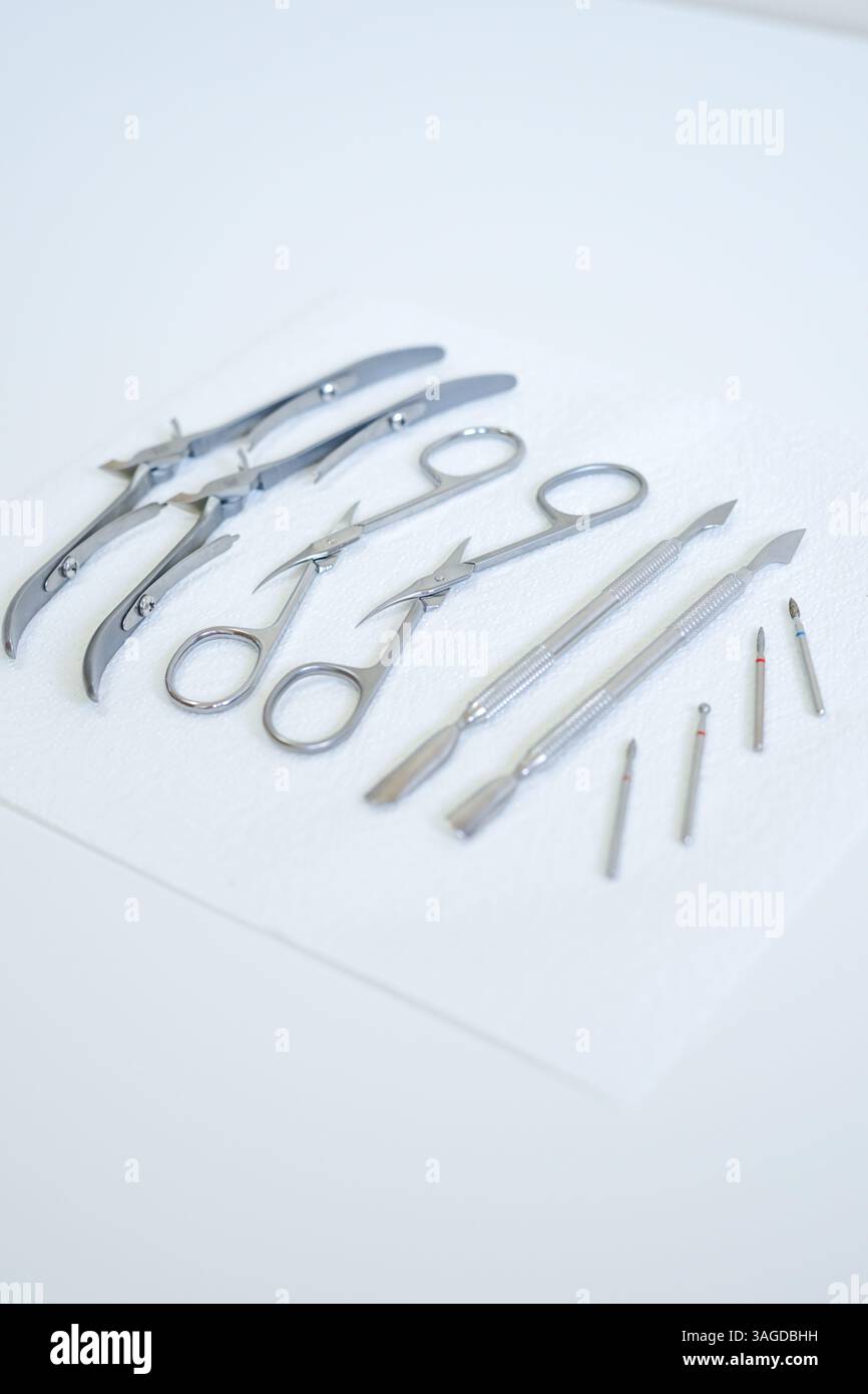 A set of clean and sterilized stainless steel manicure tools arranged ...