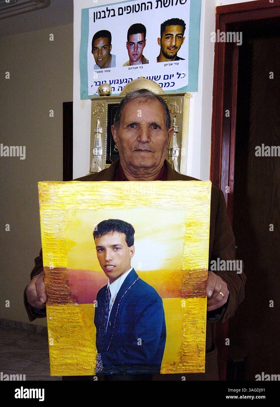 Jan 27, 2004; Amiad, ISRAEL; ABU OMAR holds a portrait of his son ...