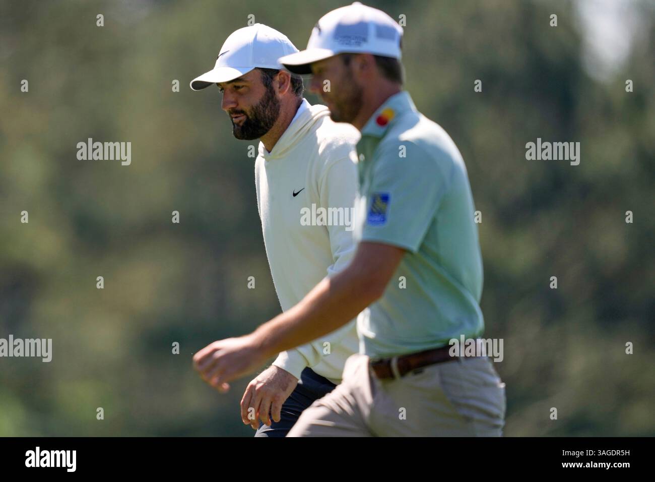Scottie Scheffler and Sam Burns, right, walk to the fourth tee during a ...