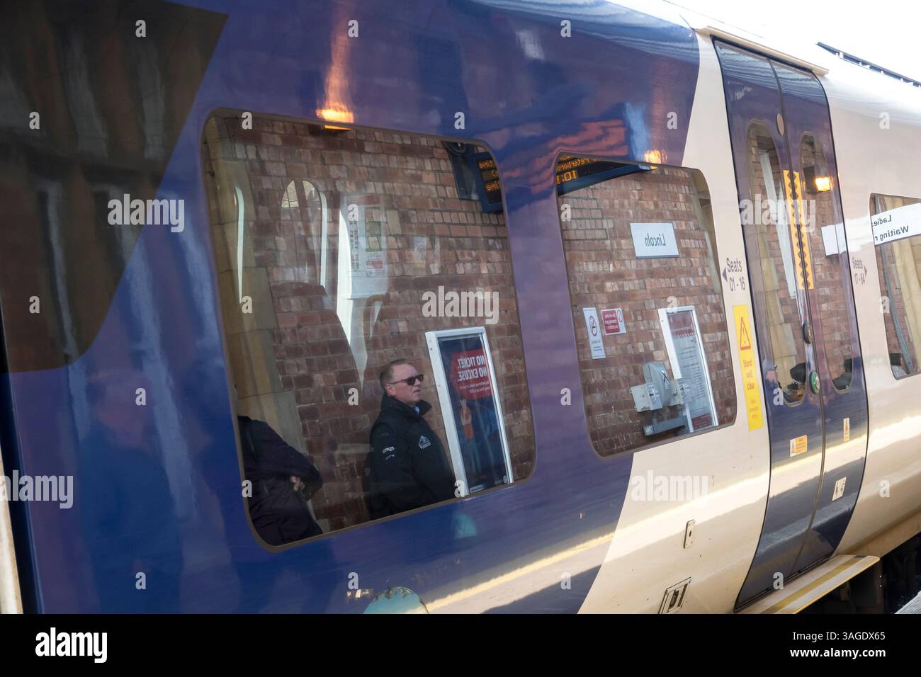 Reflection in carriage window of people waiting for train, Lincoln ...