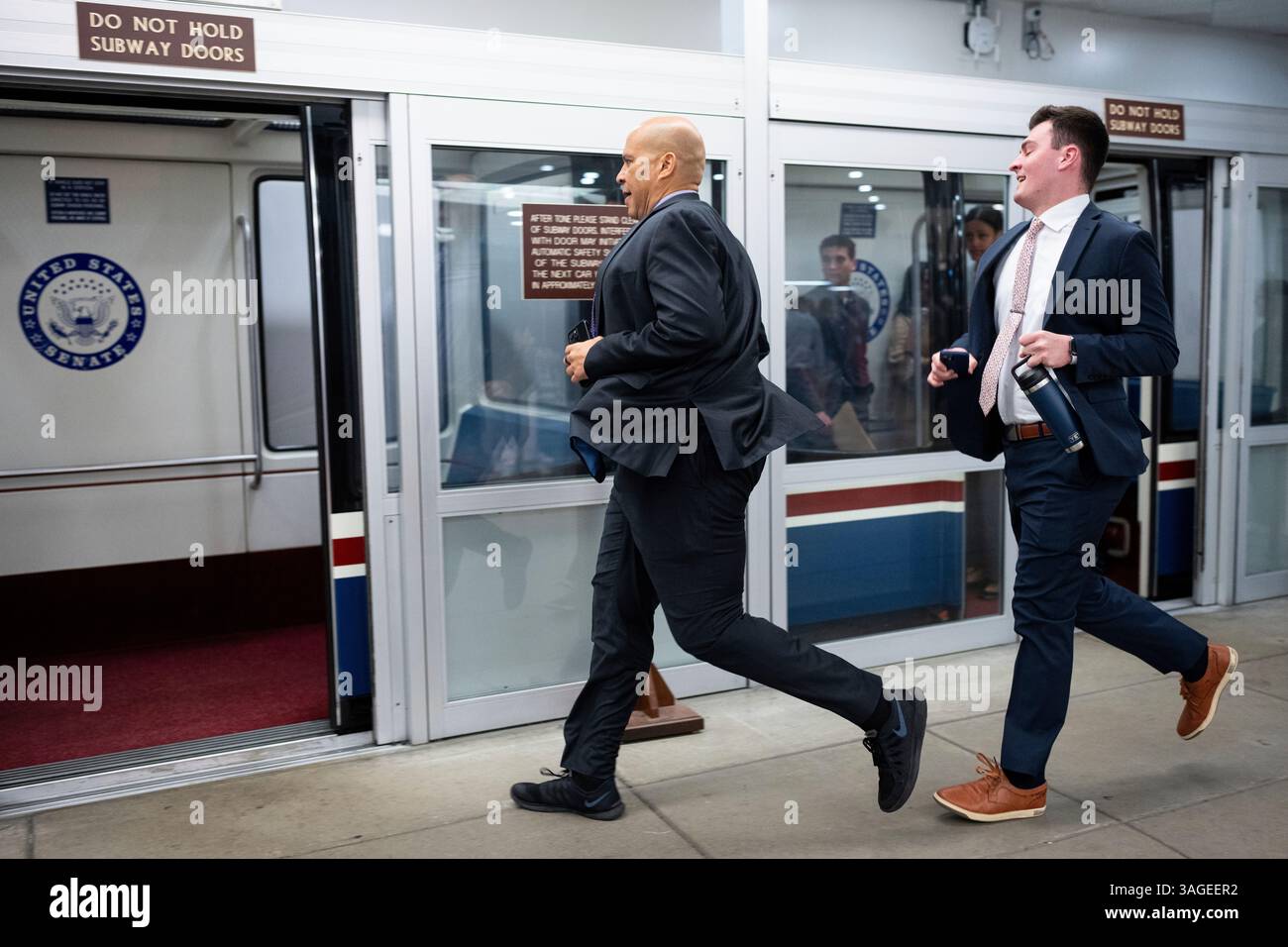 UNITED STATES - APRIL 8: Sen. Cory Booker, D-N.J., runs to catch the ...