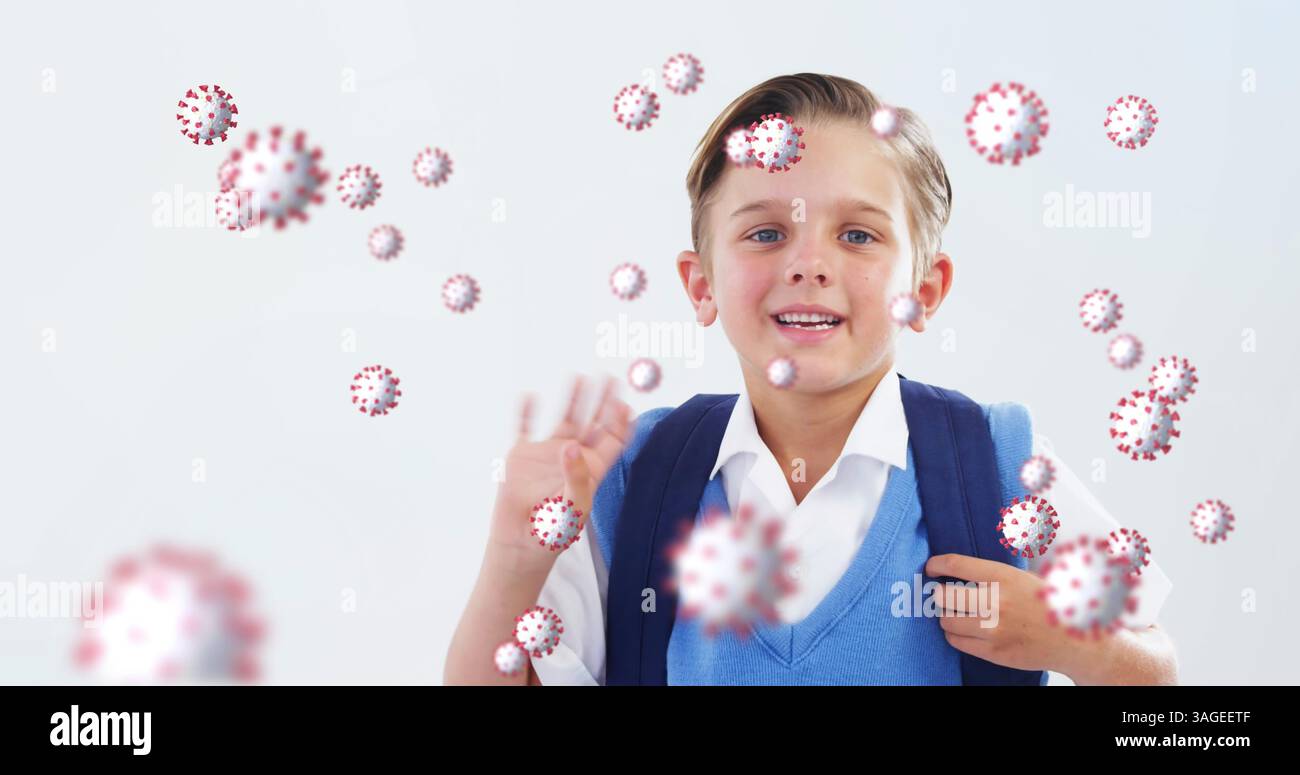 Image of Covid 19 coronavirus cells spreading over happy schoolboy ...