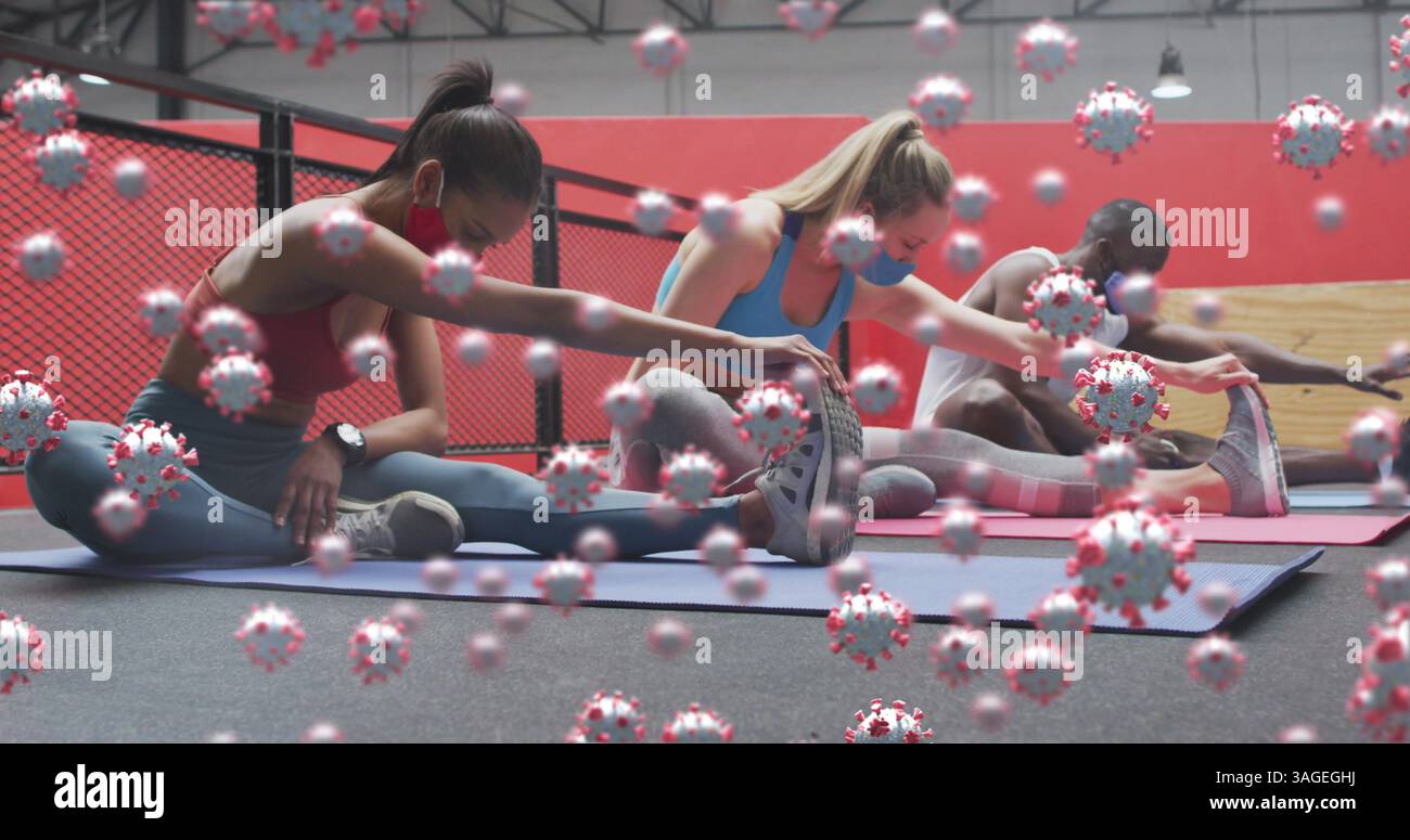 Covid-19 cells floating against fit people wearing face masks ...