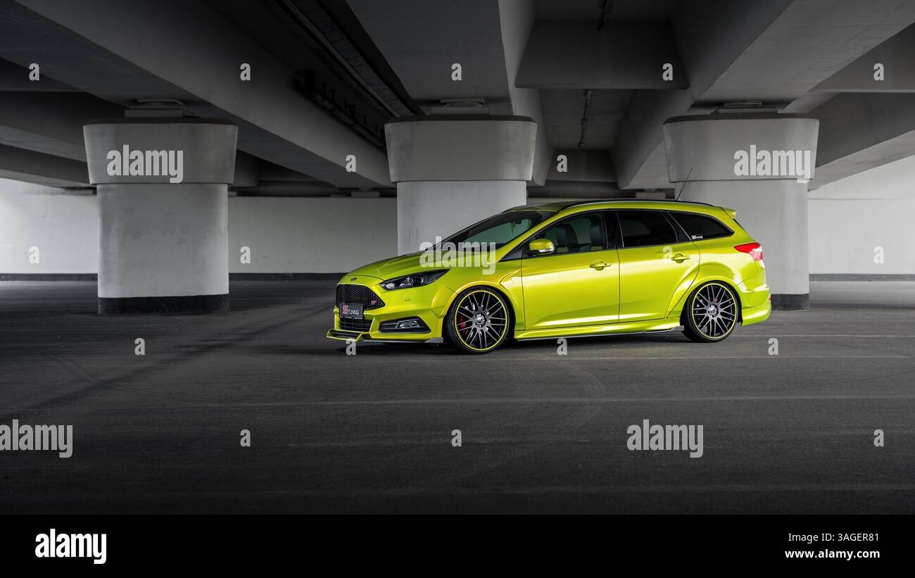 Lime green Focus ST under concrete bridge. Three quarter front view of ...