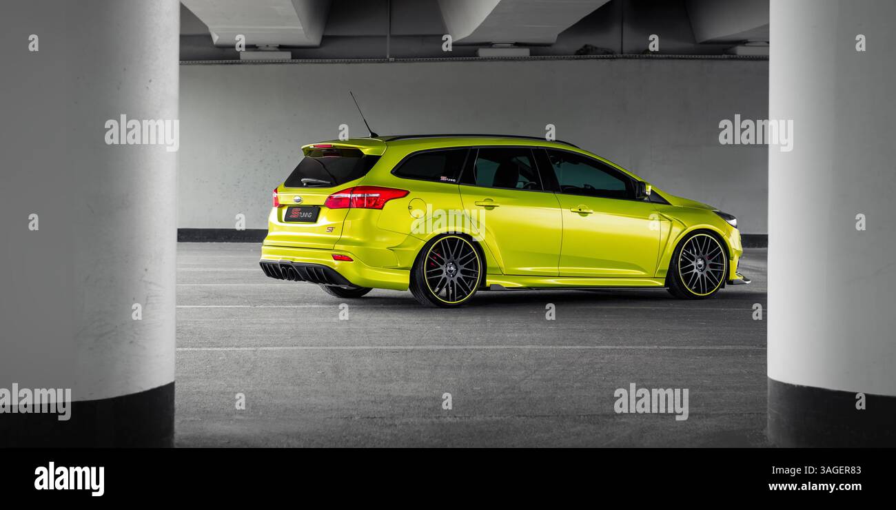 Lime green Focus ST between two pillars. Three quarter rear view of ...