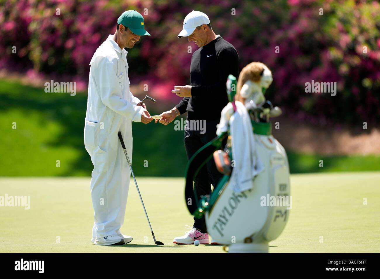 Rory McIlroy, of Northern Ireland, interacts with caddie Harry Diamond ...