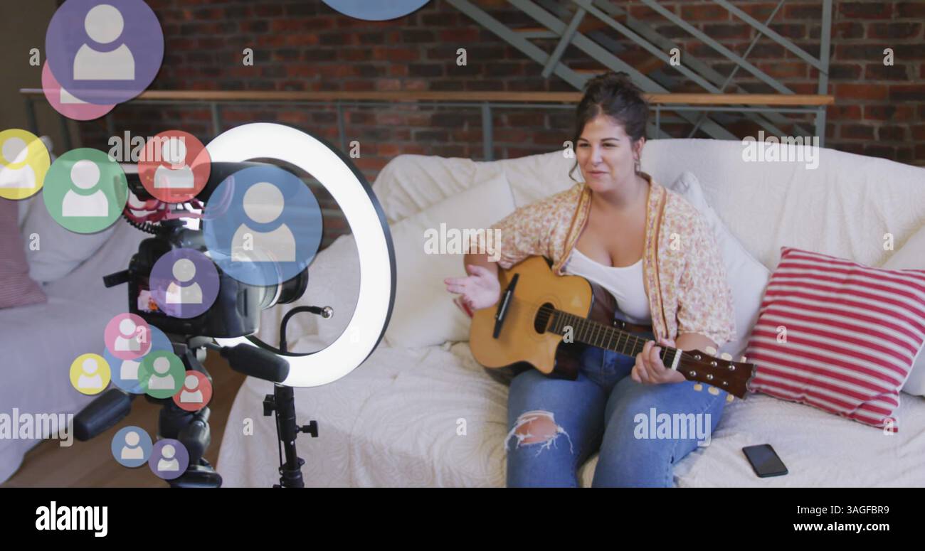 Image of people icons over female vlogger playing guitar recording vlog ...