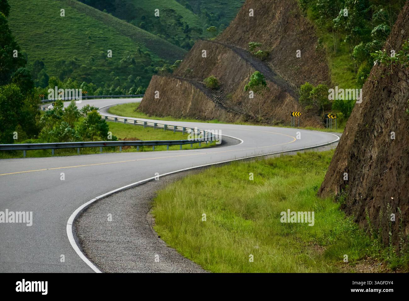 road through the mountains and green hills in Africa Uganda black road ...