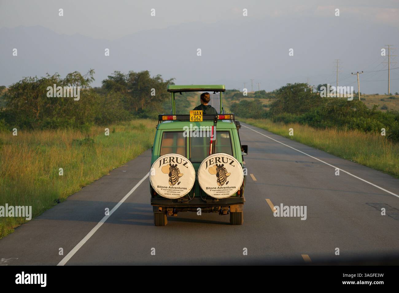 Safari vehicle Toyota Land Cruiser in game drive tourists taking photos ...