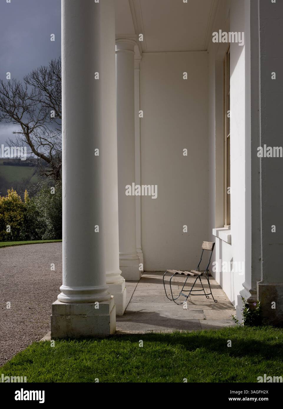 A simple lone chair on a veranda in an English country house in Devon ...
