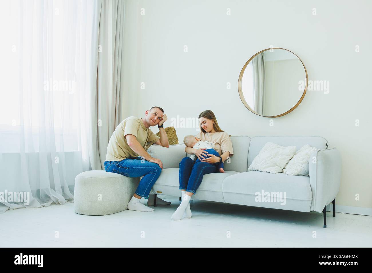 A loving family scene shows devoted parents nurturing their baby in a ...