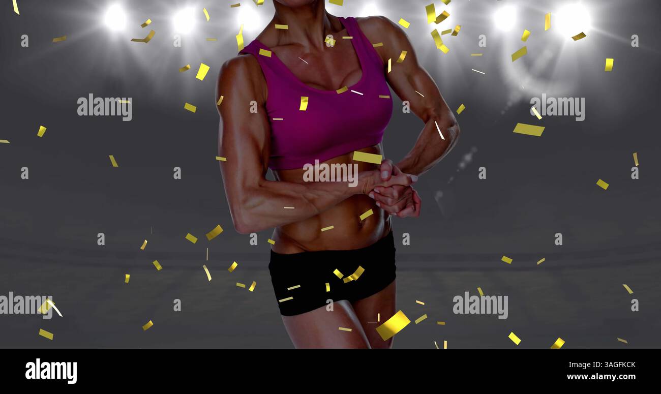 Golden confetti falling over mid section of female athlete flexing her ...