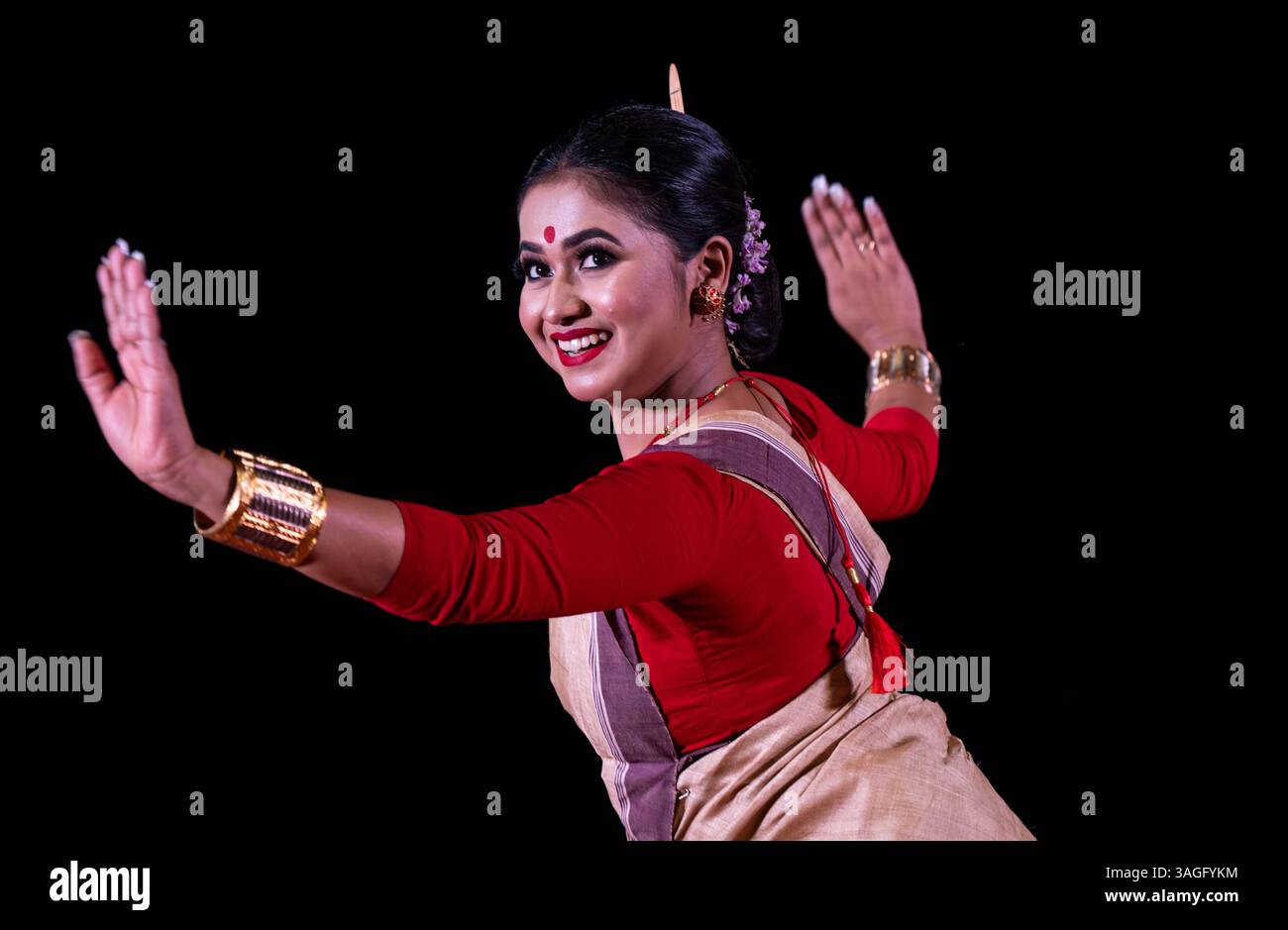 An instructor dances as participants follow the dance steps in a Bihu ...
