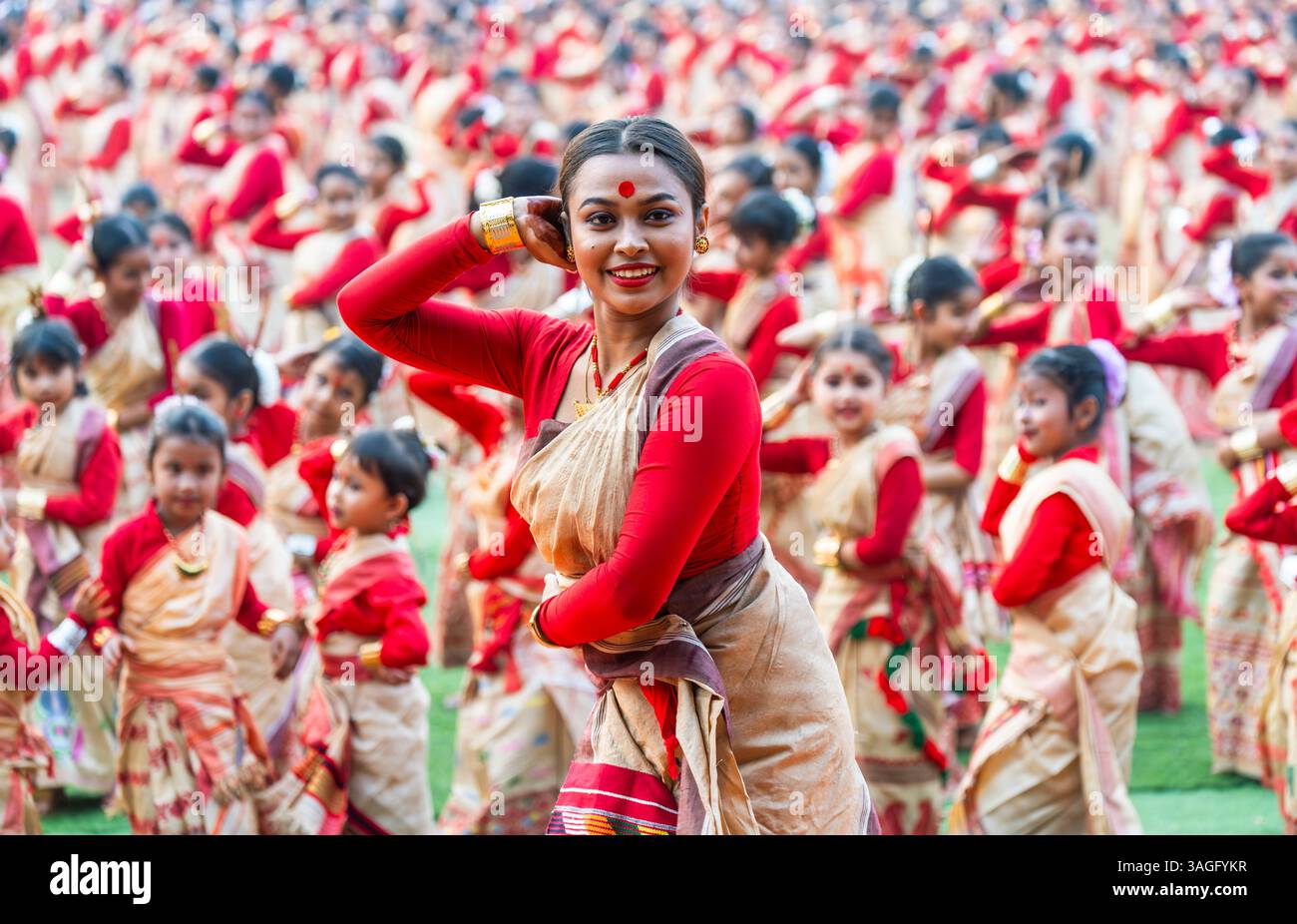 An instructor dances as participants follow the dance steps in a Bihu ...