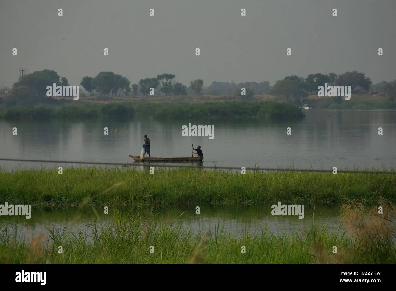 fisherman rowing boat on the Nile, African fishermen with boat and net ...