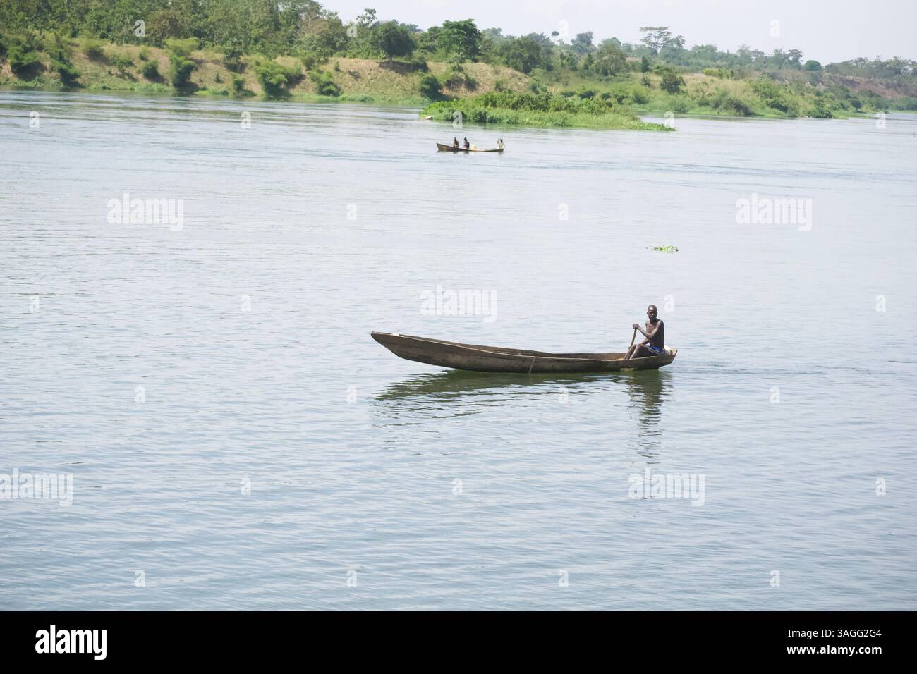 fisherman rowing boat on the Nile, African fishermen with boat and net ...