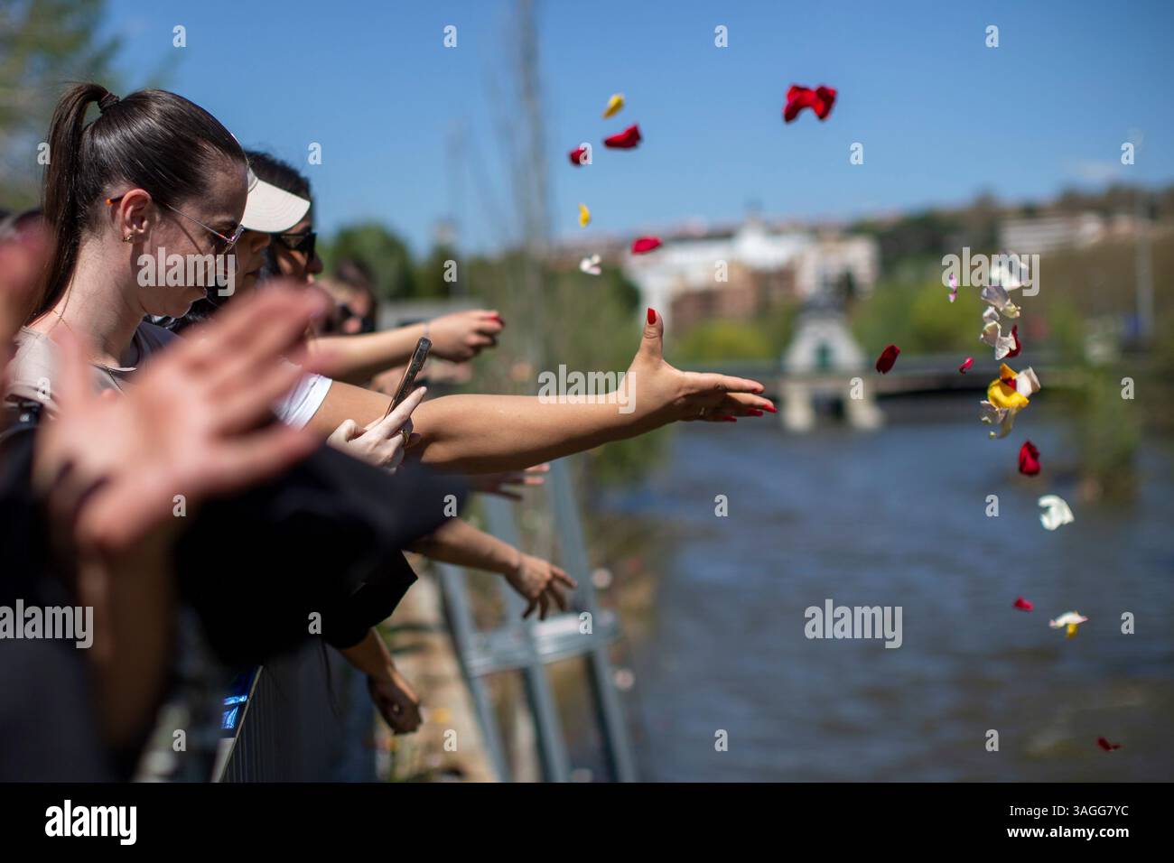 People throw rose petals into the river, during the institutional act ...